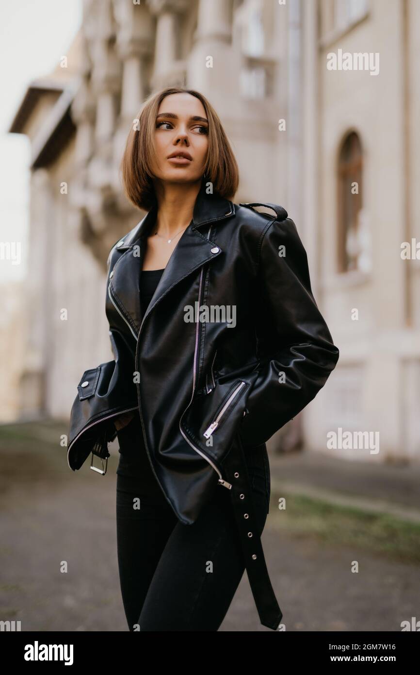 beautiful young girl in leather jacket and jeans resting outdoors Stock ...