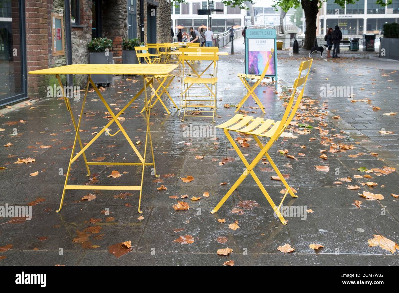 Wet autumn day in Bristol UK. Empty cafe with yellow tables Stock Photo ...