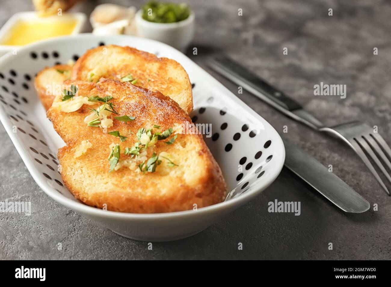 Plate with delicious homemade garlic bread on table Stock Photo - Alamy
