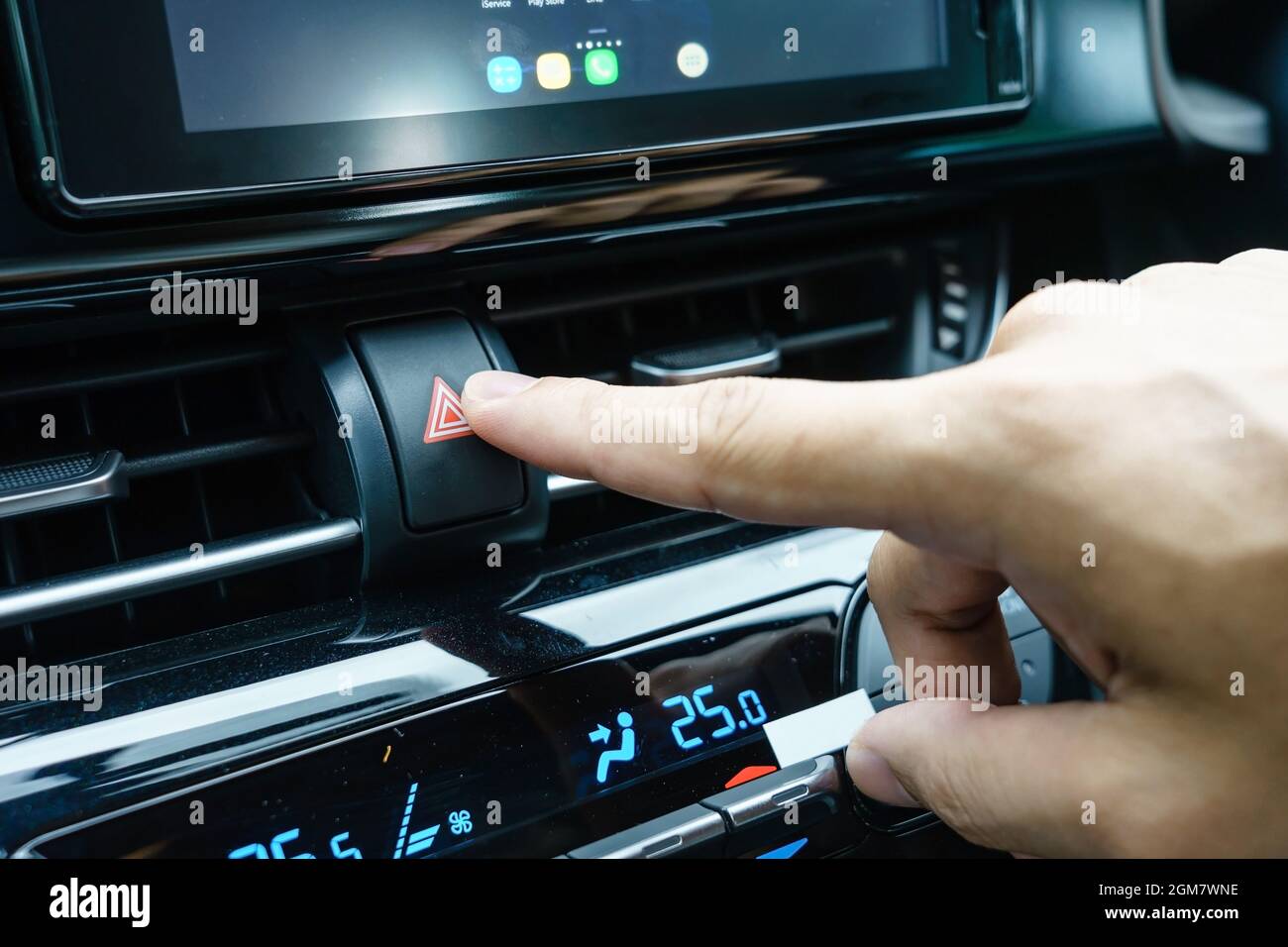Closeup of man's hand pressing emergency stop button in car Stock Photo ...