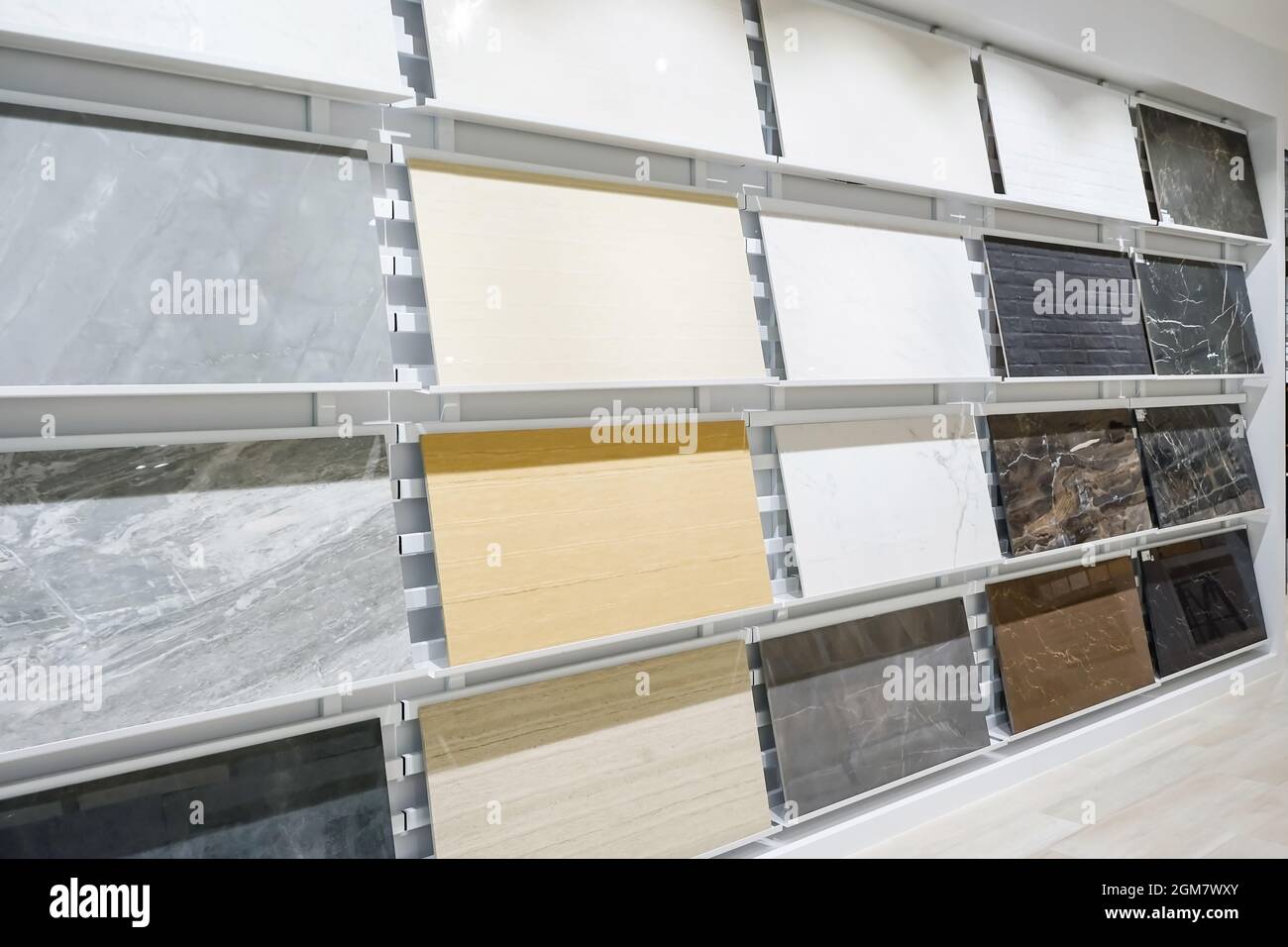 Colorful samples of a stone tile in store. Marble and granite flooring ...