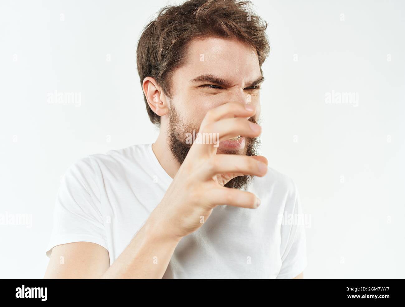 Man in a white t-shirt hand gestures anger close-up Stock Photo - Alamy