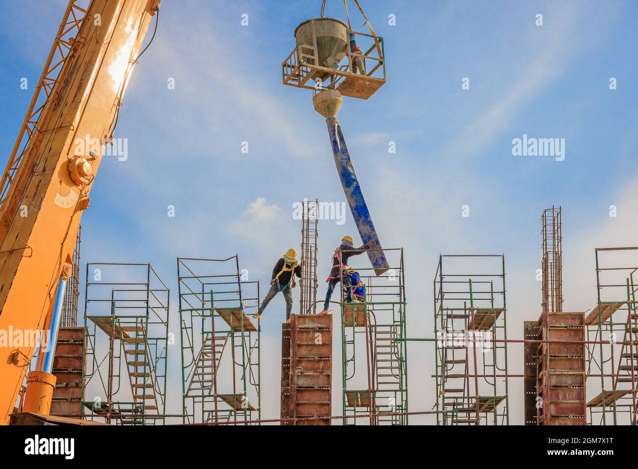 Construction workers working on scaffolding at a high level by the ...