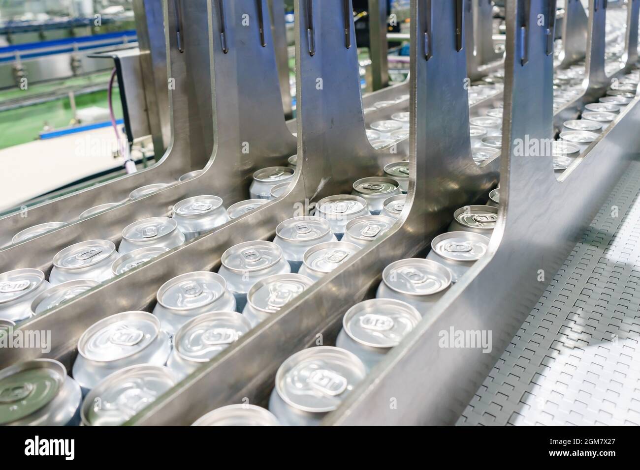 Conveyor line carrying thousands aluminum beverage cans at factory ...