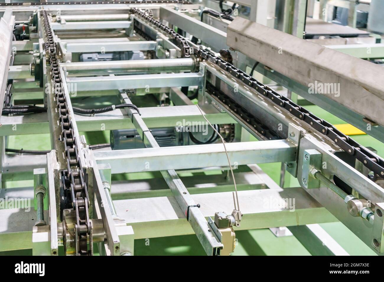 Detail of chain of roller conveyor on production line.- Shallow DOF ...