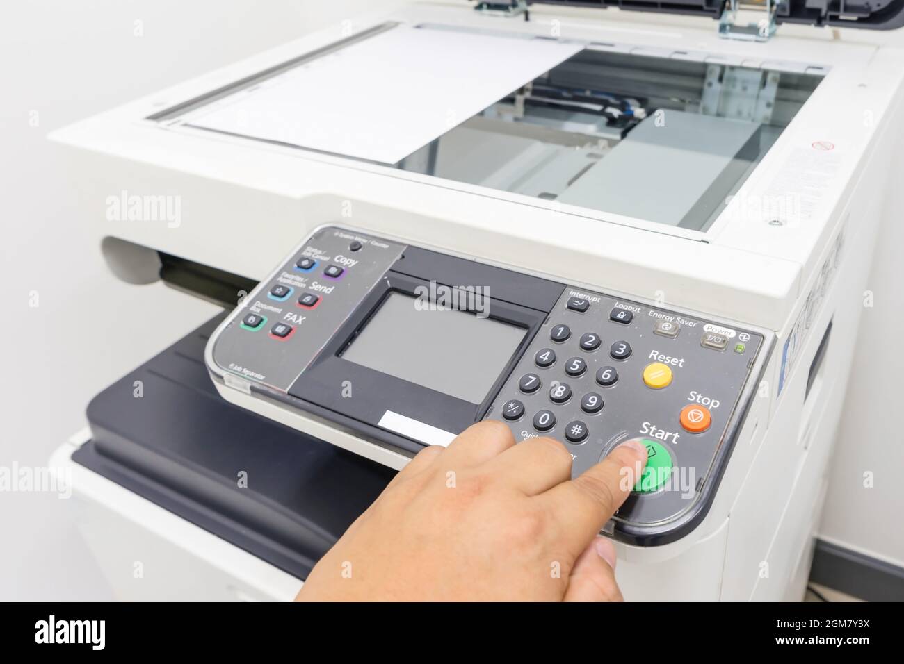 Man copying paper from Photocopier with access control for scanning key ...