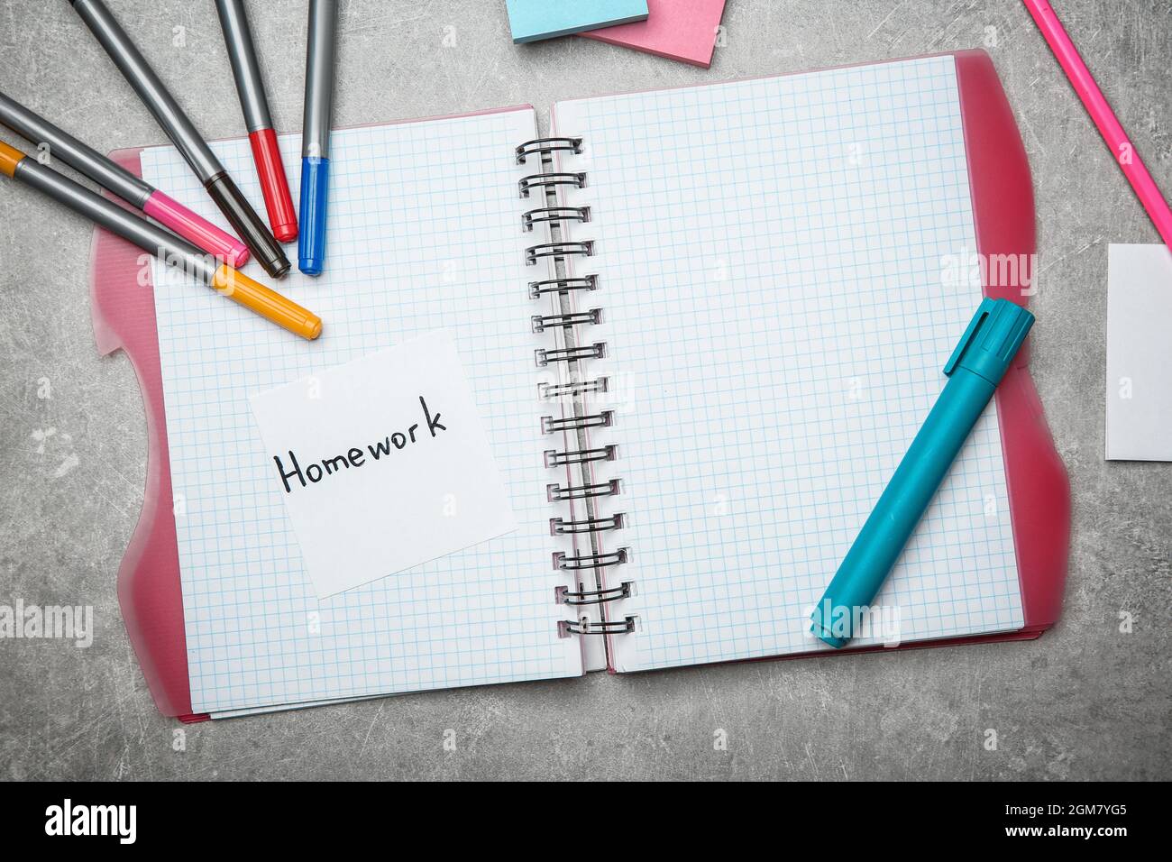 Notebook, sheet of paper with word "Homework" and stationery on grey ...
