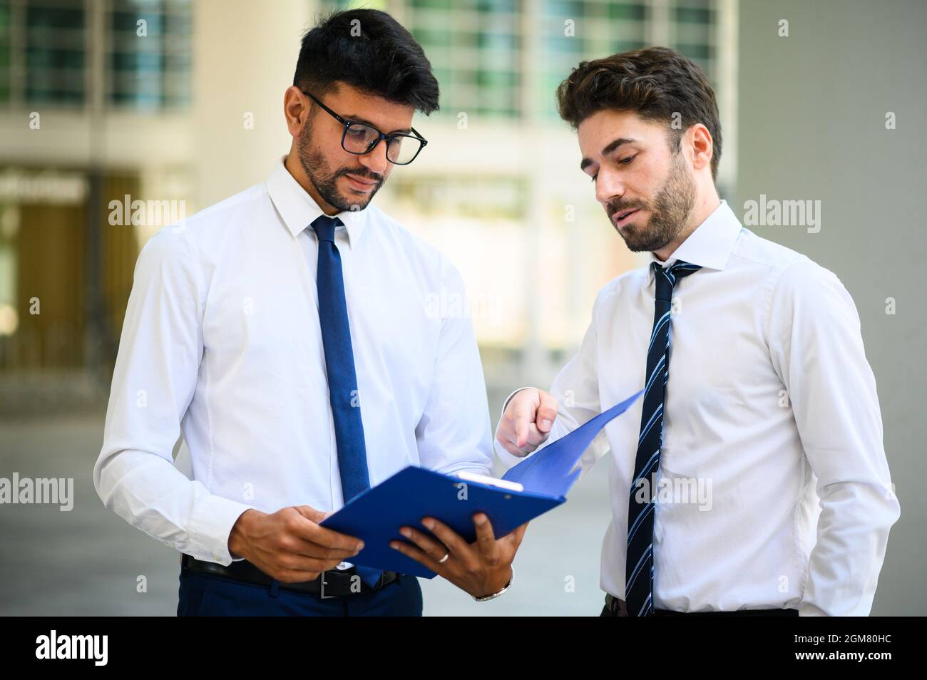 Business people reading a document together Stock Photo - Alamy