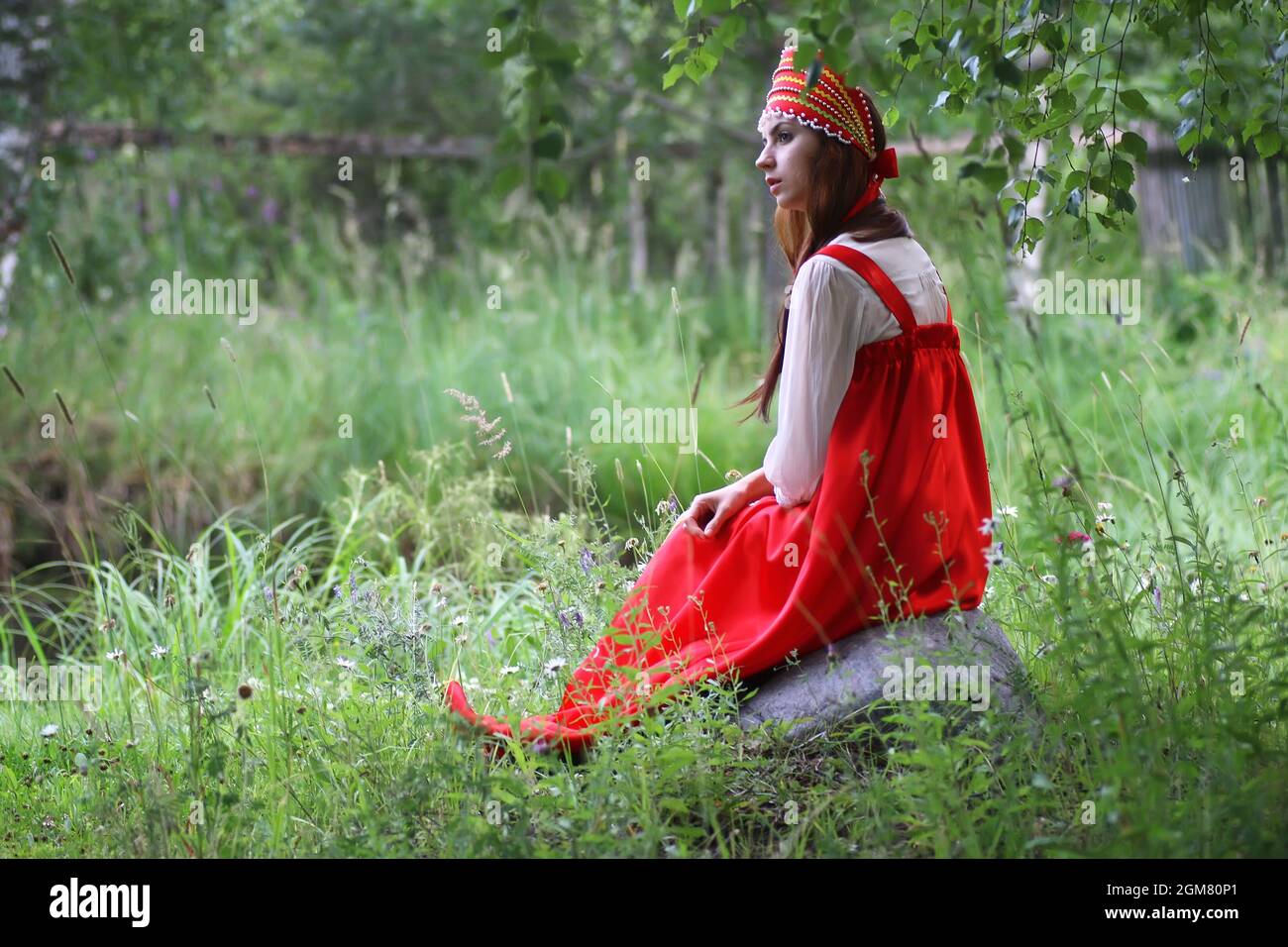 Slav in traditional dress is sitting in nature Stock Photo - Alamy