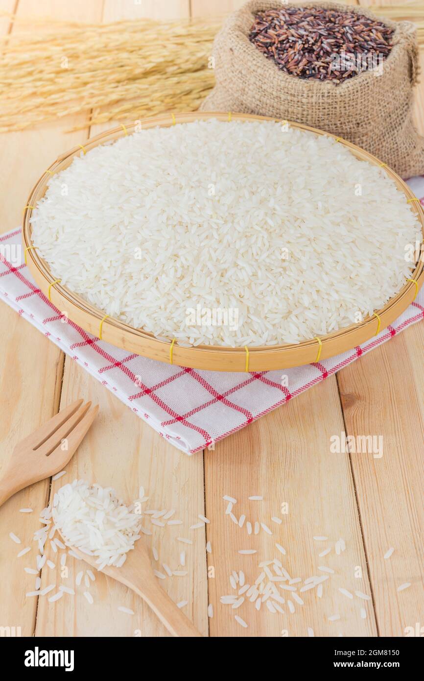 Thai jasmine white rice and riceberry rice in bamboo basket and bag on ...