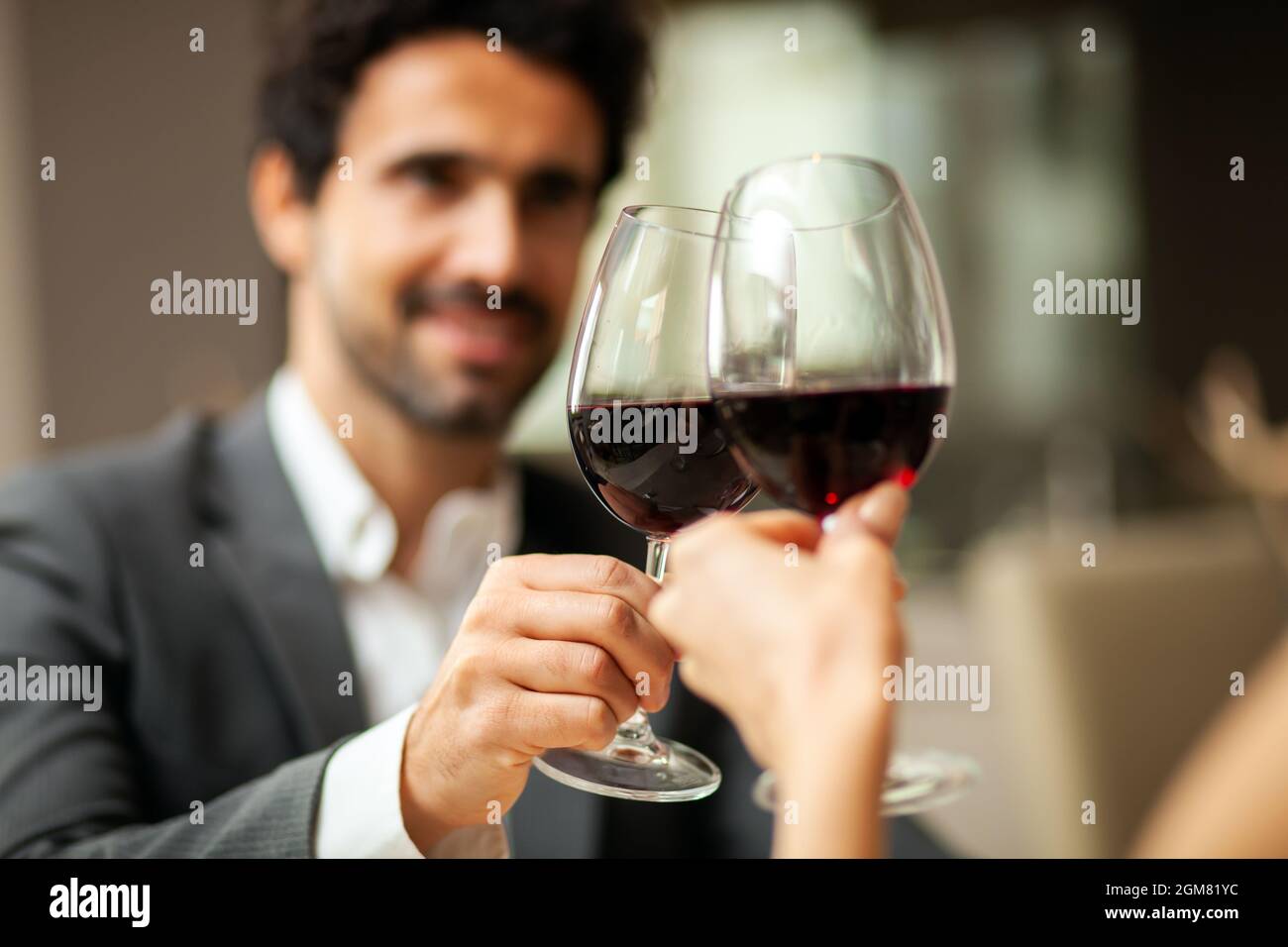 Handsome man tasting a glass of red wine Stock Photo - Alamy