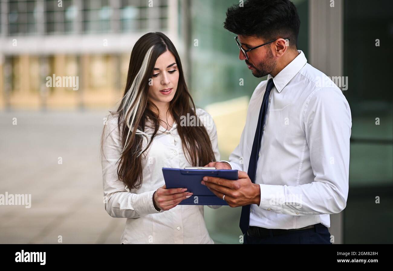 Business people reading a document together Stock Photo - Alamy