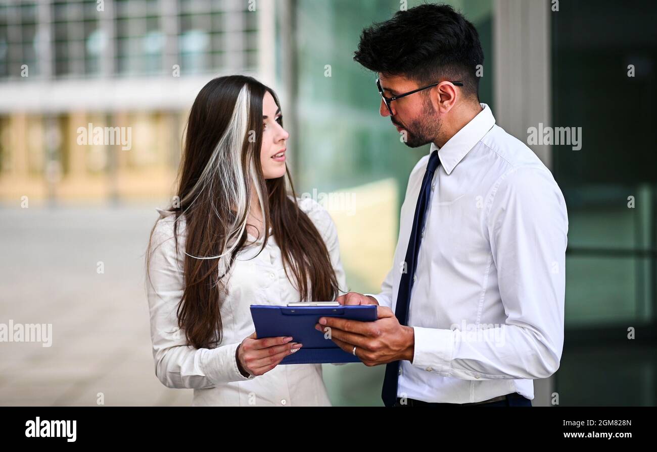 Business people reading a document together Stock Photo - Alamy