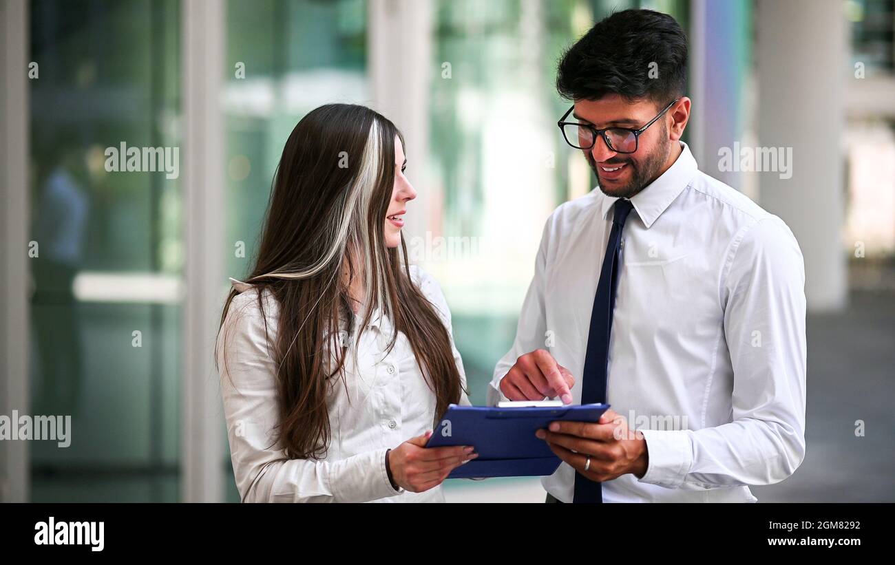 Business people reading a document together Stock Photo - Alamy