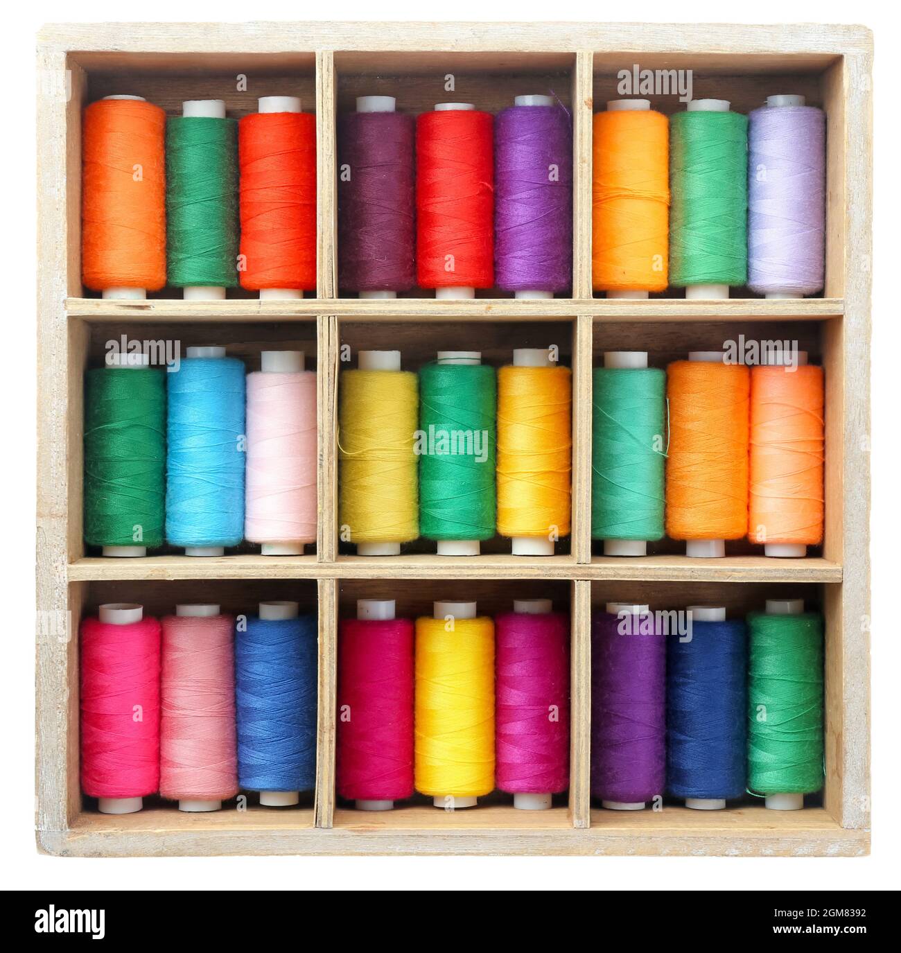 Set of color sewing threads in wooden compartment box on white ...