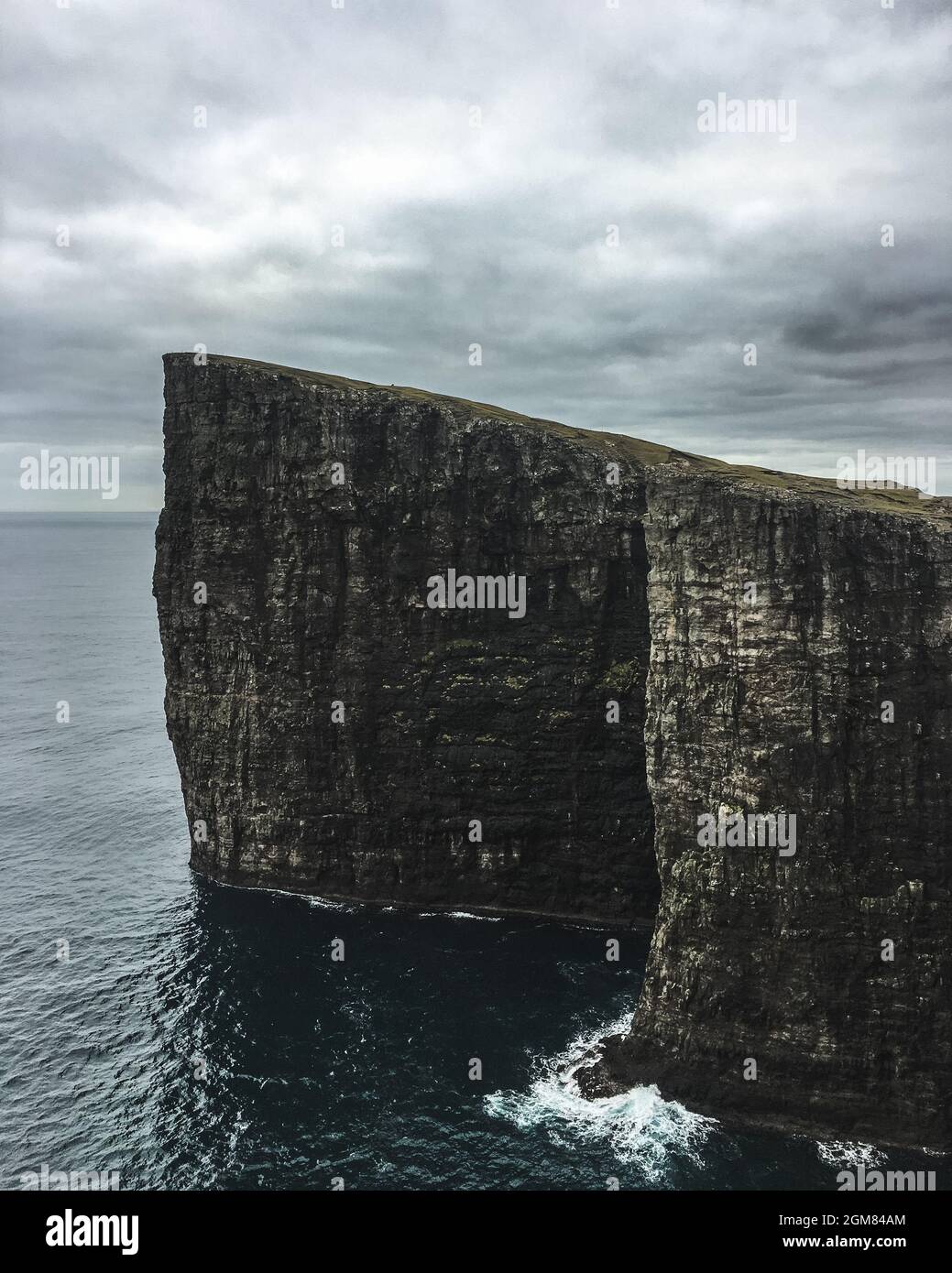 Black cliffs formation in the Atlantic ocean, Faroe Islands. Towering ...