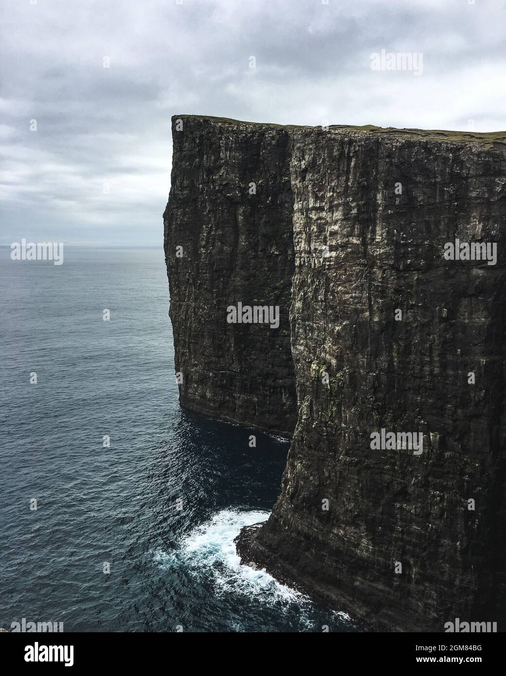 Black cliffs formation in the Atlantic ocean, Faroe Islands. Towering ...