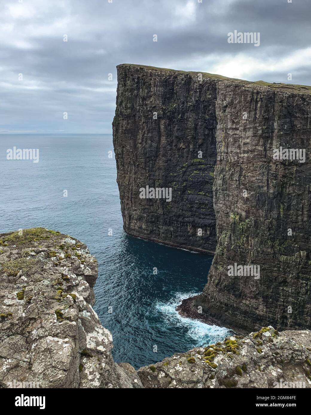 Black cliffs formation in the Atlantic ocean, Faroe Islands. Towering ...