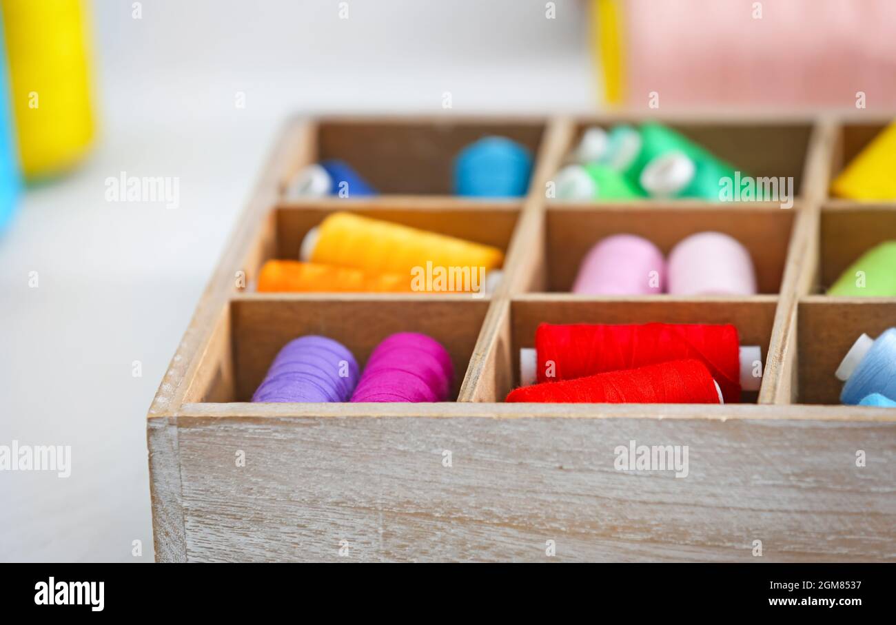 Set of color sewing threads in wooden compartment box, closeup Stock ...