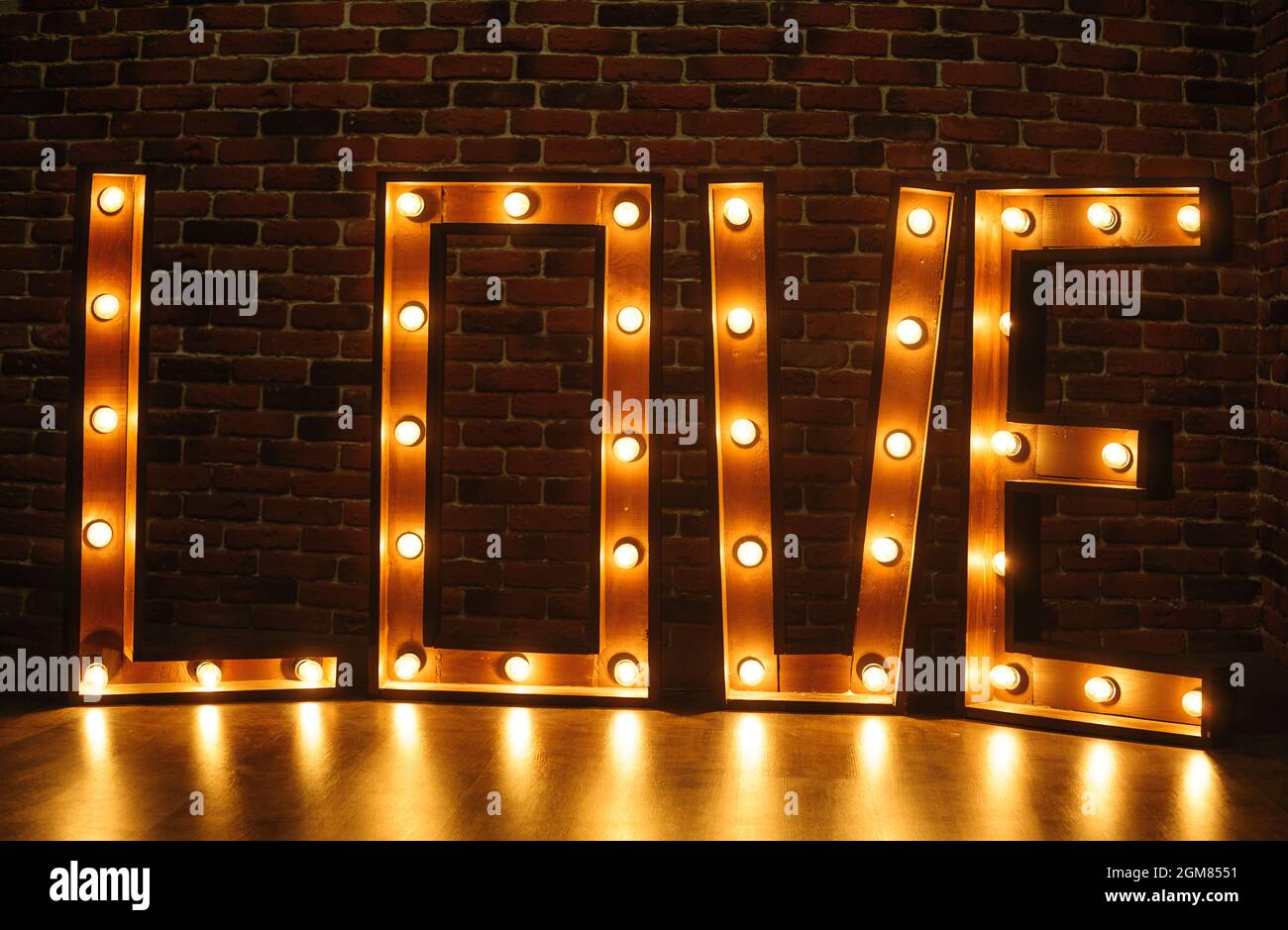 large wooden word love with lights in the studio Stock Photo - Alamy