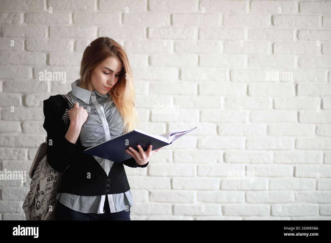 Young pretty blonde girl student before class Stock Photo - Alamy