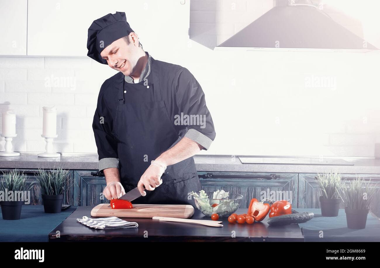 Man cook preparing food at the kitchen table of vegetables Stock Photo ...