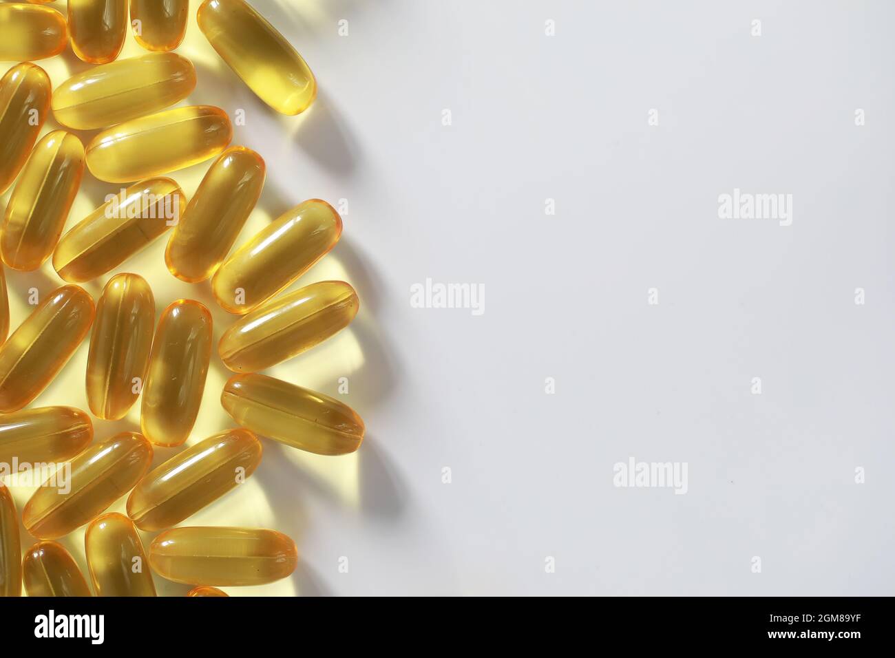 Medical medicines and supplements transparent capsules of yellow color ...