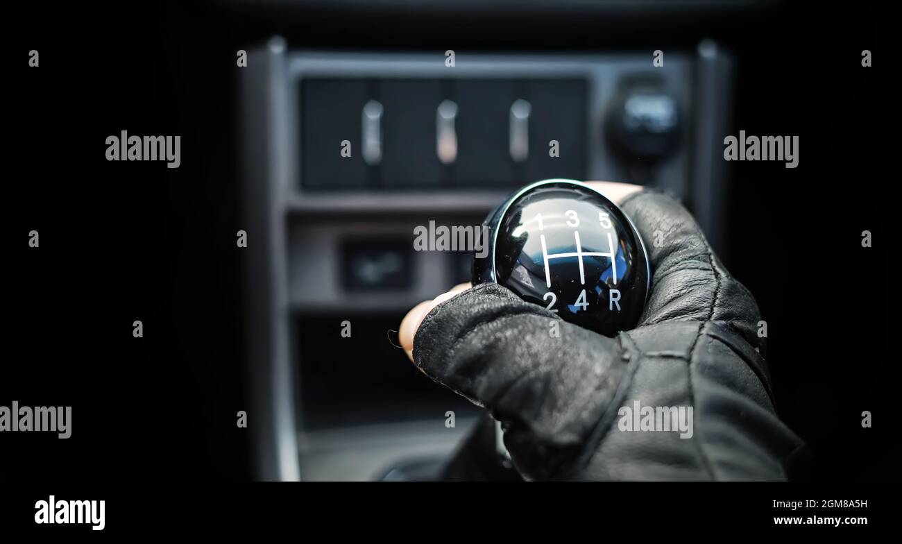 Gear lever. Manual Transmission. Hand on the gear shift in a car Stock ...