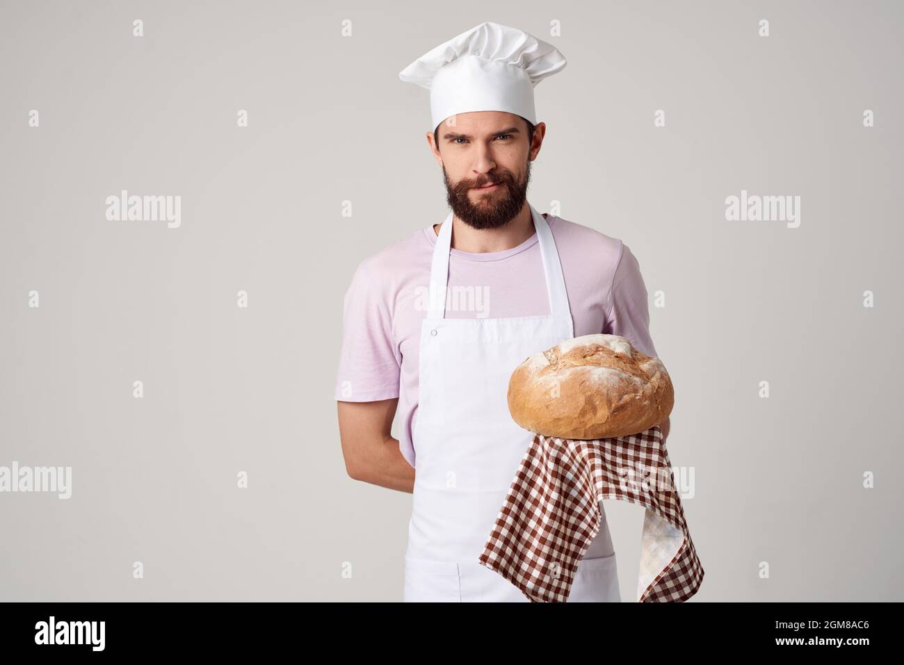 a man in a chef's uniform with bread in his hands cooking baking Stock ...