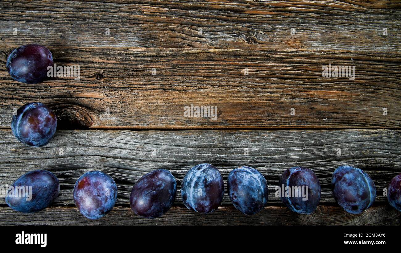 Italian plums table top on wooden background Stock Photo - Alamy