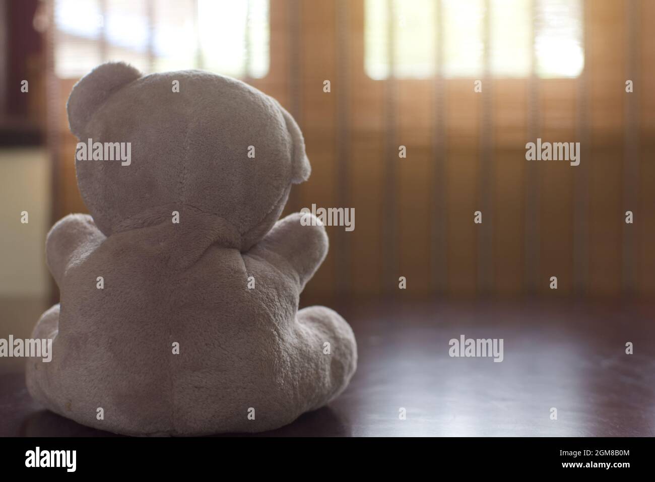 Alone teddy bear sitting on wood table, Sad concept Stock Photo - Alamy