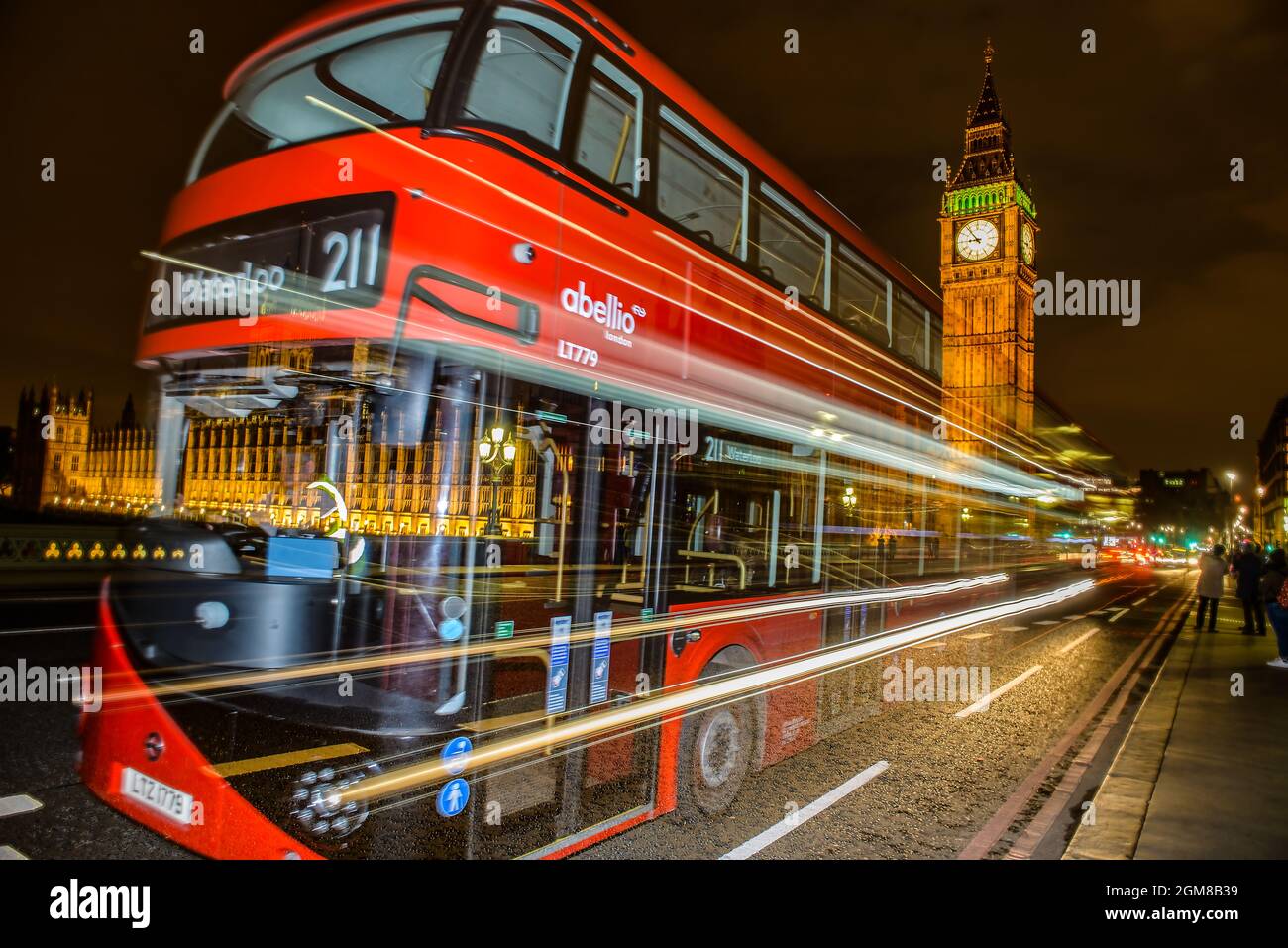London Bus at night infront of Big Ben Stock Photo - Alamy