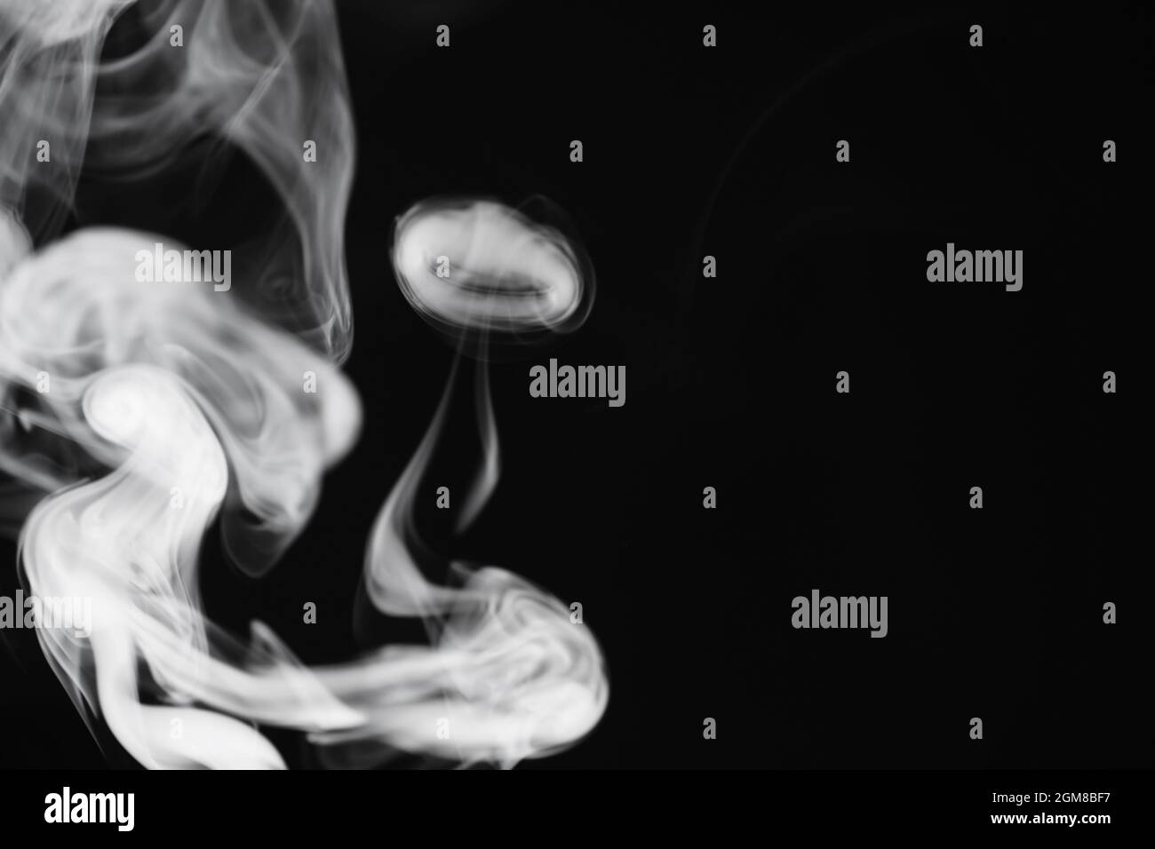 White smoke on a black background. Texture of smoke. Clubs of white ...