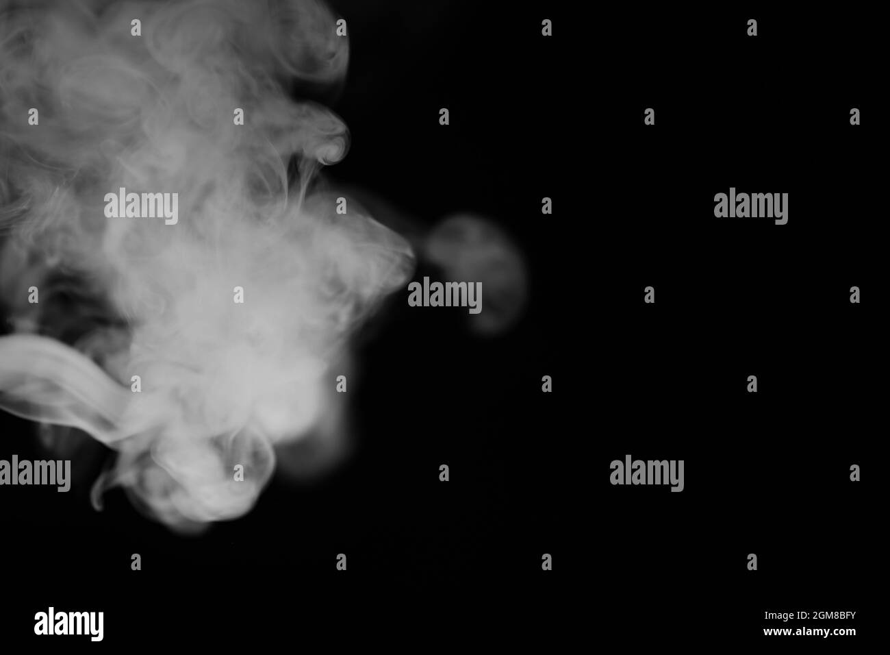 White smoke on a black background. Texture of smoke. Clubs of white ...