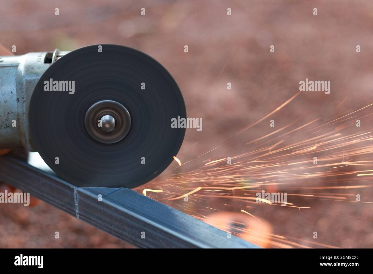 Technician cutting steel with tool in the workplace Stock Photo - Alamy