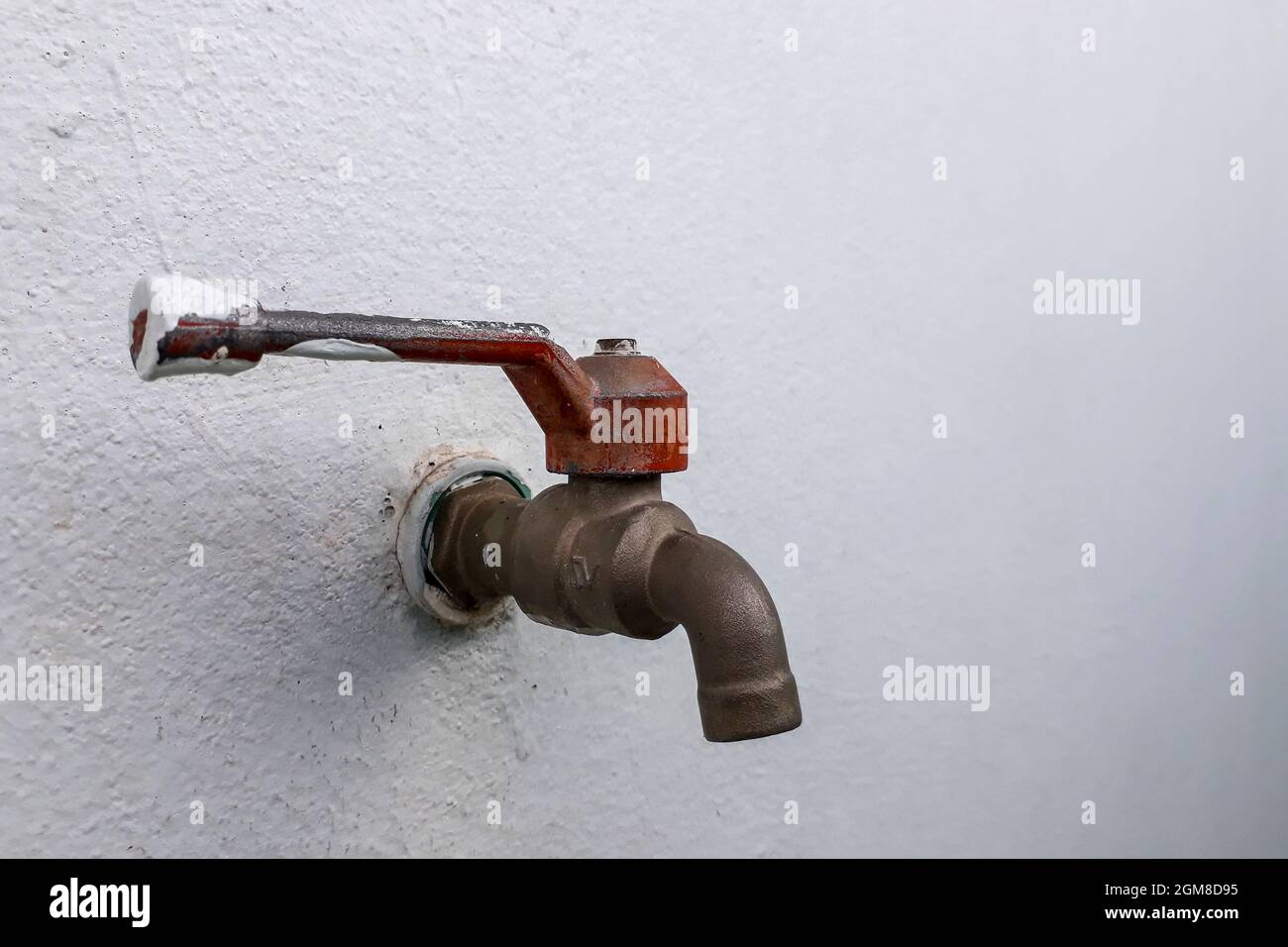 The empty water tap next to the wall shows the drought Stock Photo - Alamy