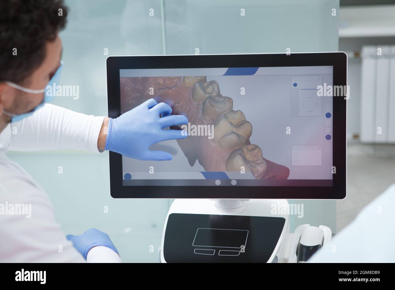 Dentist examining dental scan of a patient on the computer screen Stock ...