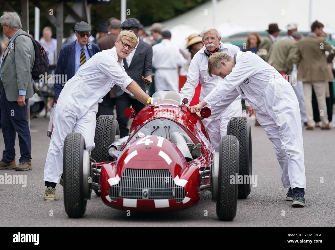 An Alpha Romeo 158 'alfetta' is pushed out of the paddock during the ...