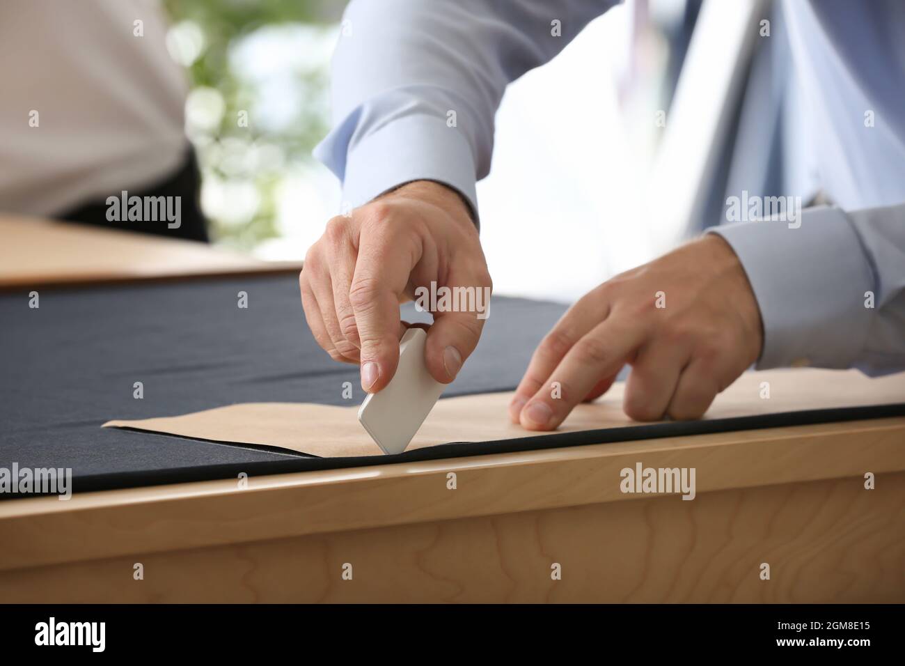 Tailor marking fabric with chalk in atelier Stock Photo - Alamy