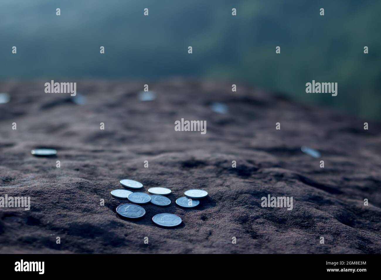 Money coin placed on the stone. Expressing economic concept Stock Photo ...