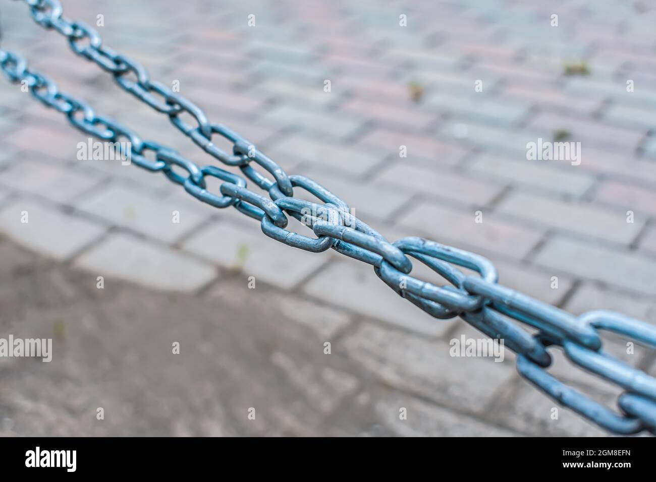 Long tensioned metal chain over the road with double winding Stock ...