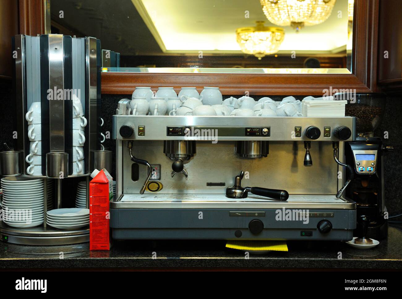 Coffee station. Coffee machine plates and cups set on a table in ...
