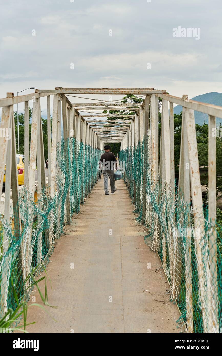 Pedestrian bridge with a person crossing Stock Photo - Alamy