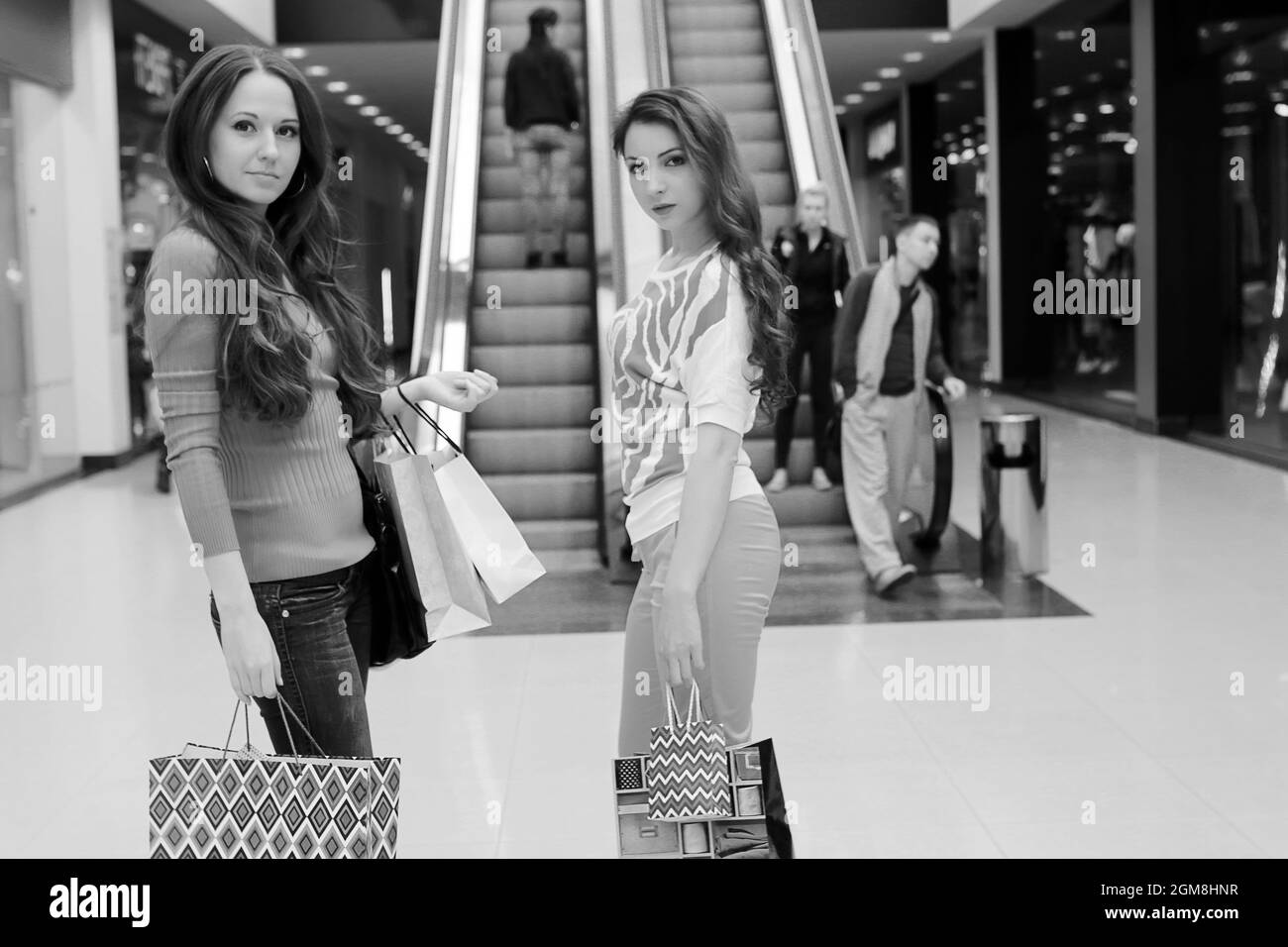 Two cute girls go shopping in the mall Stock Photo - Alamy