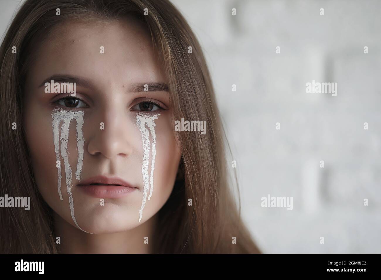 Beautiful girl with tears in eyes. Young girl with painted tears posing ...