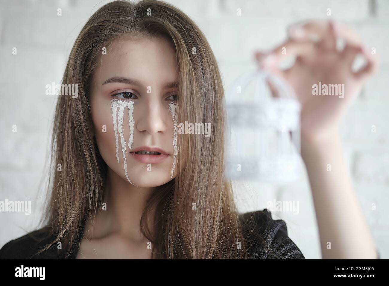 Beautiful girl with tears in eyes. Young girl with painted tears posing ...