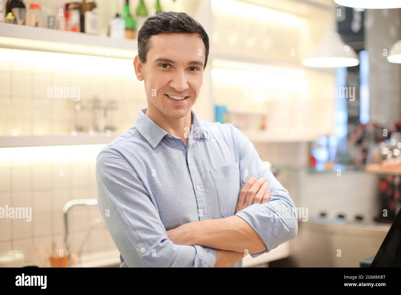 Young man standing in store. Small business owner portrait Stock Photo ...