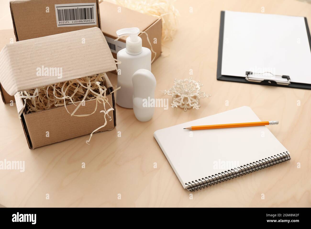 Preparing parcels for shipment to customer on table Stock Photo - Alamy