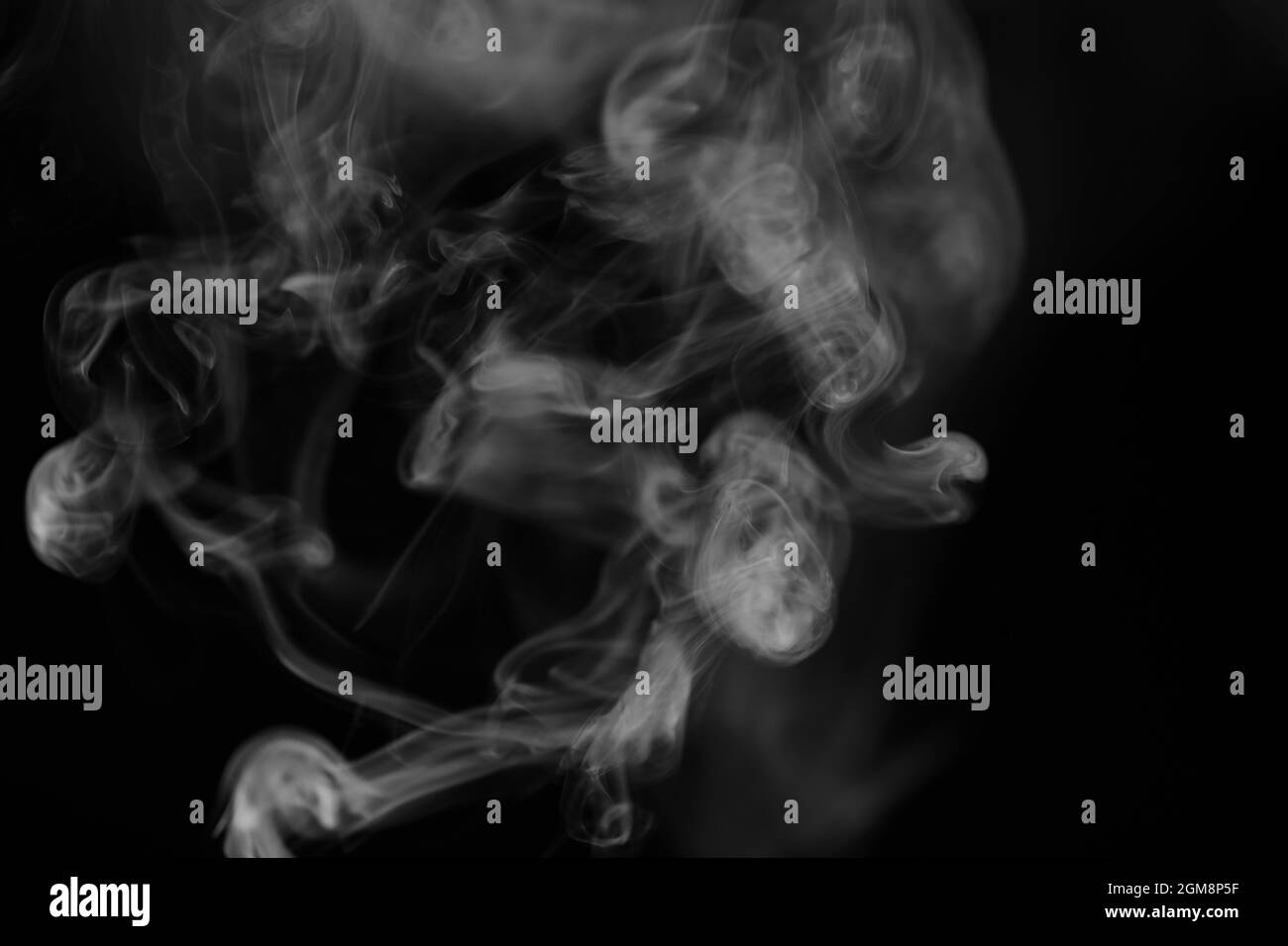 White smoke on a black background. Texture of smoke. Clubs of white ...