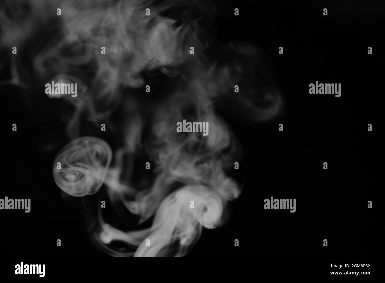 White smoke on a black background. Texture of smoke. Clubs of white ...